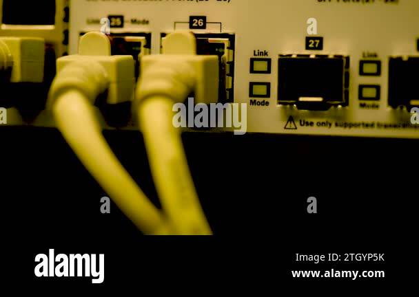 blinking LED lights in a server rack with RJ45 and fiber optic cable ...