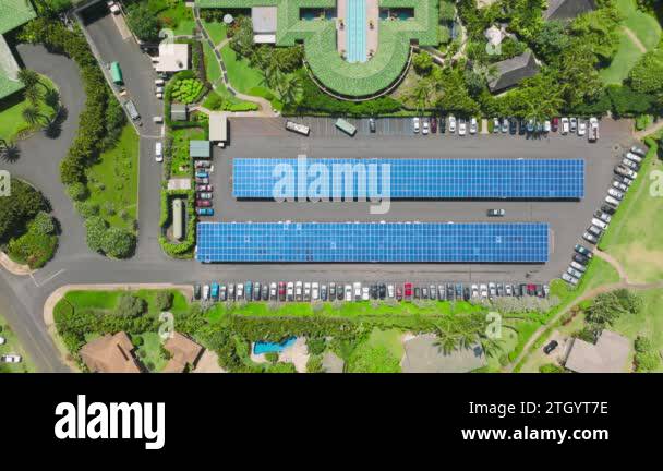 Aerial cars parking under solar panels. 4K electric and engine vehicles ...