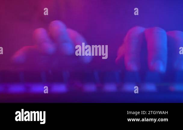Male Hands Rapidly Typing On A Computer Keyboard In Smoky Neon Lighting Unrecognizable Guy