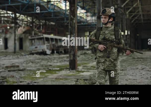 Confident female soldier in special forces uniform walking through ...