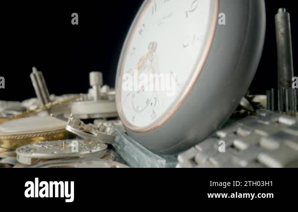 Grey vintage pocket watch dial on pile of clockwork parts. Round old ...