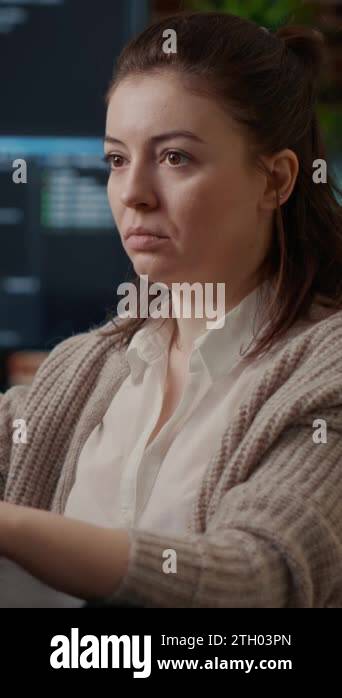 Vertical video Caucasian system engineer working focused looking at ...