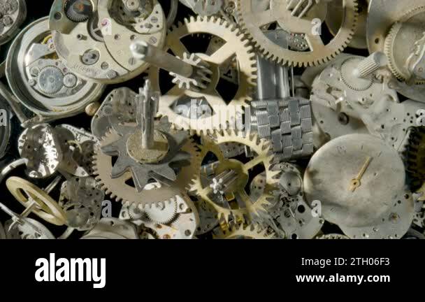 A pile of metal internal parts of an old clock. Dial, clockwork ...