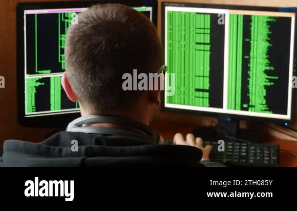 Hacker in glasses breaking code. Criminal hacker penetrating network ...