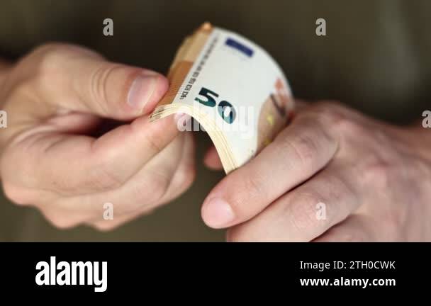 Man Counting Money. Close up of male hands counting pile of 50 euro ...