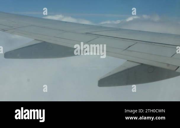 Shooting an airplane wing in small clouds at high altitude. Shooting ...
