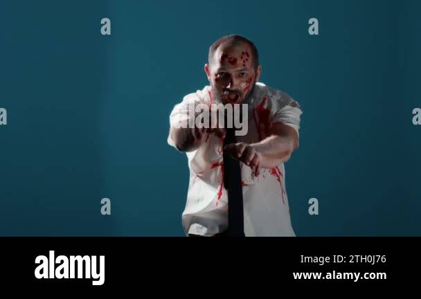 Growling spooky zombie prowling at camera on blue background. Crazy ...