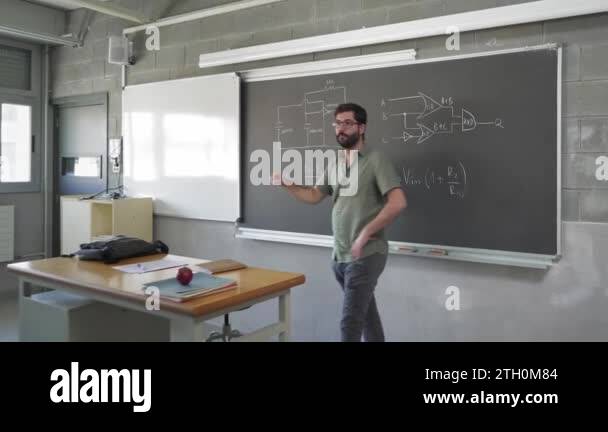 High School Teacher explaining electronics circuits To Pupils learning ...