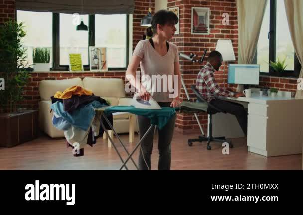 Aggressive adult ironing blouse and getting angry at husband, wife ...