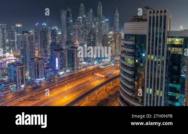 Dubai marina tallest block of skyscrapers night timelapse. Aerial view ...