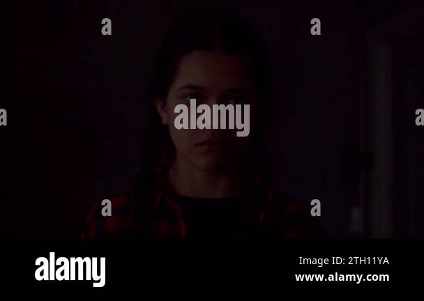 Spooky mysterious cute teenage girl frightening someone in darkness ...