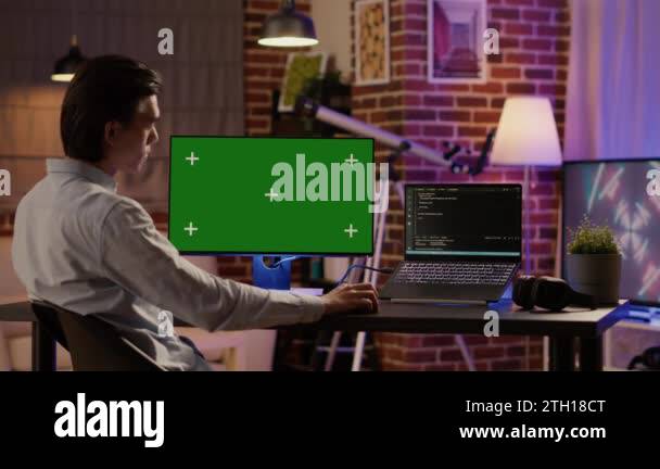 Office Employee Analyzing Greenscreen On Computer Monitor At Home Desk Using Blank Chroma Key