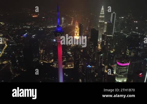 Rotating view of Menara Kuala Lumpur Tower at night. Aerial view of ...