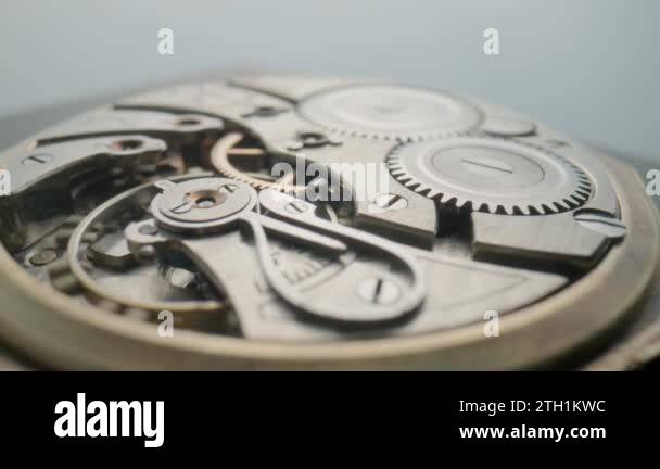 Macro shot of the internal parts of antique pocket watch on a light ...