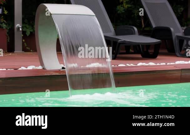 Stainless steel swimming pool wall waterfall jet on luxury resort ...