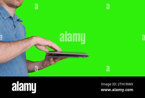 Young man opens laptop points to screen hand. Side view, chroma key ...