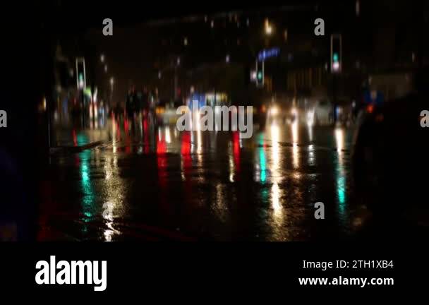 Night street in a big city after a heavy rain. The frame shows a ...