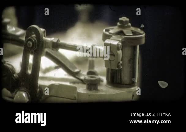 Pan down on industrial, heavy duty sewing machine as it is used to ...