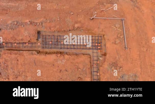 On a construction site, steel is placed in trench for the foundation of ...