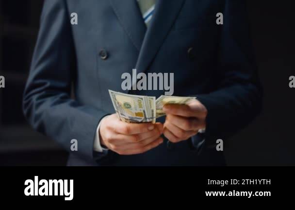 Smiling successful business man counting cash hundreds dollars close up ...