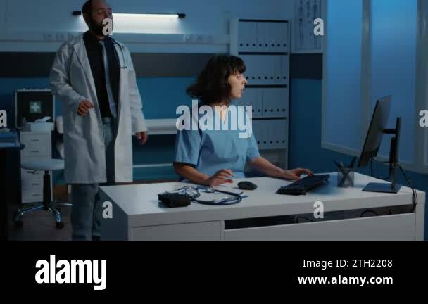 Practitioner medic aggressing nurse late at night in hospital office ...