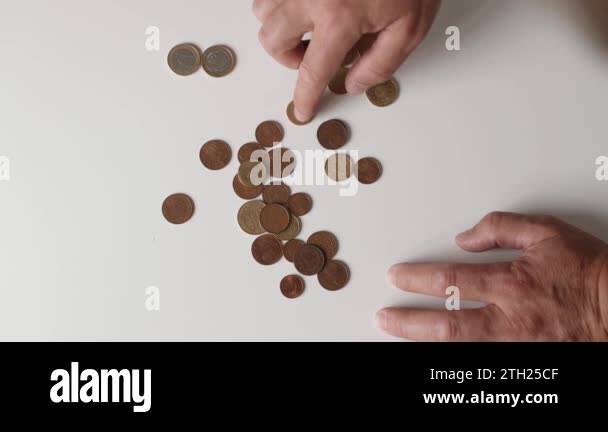 Old Mans hands counting coins on white desk. Elderly poor person ...
