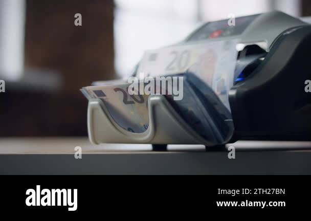 Euro currency counting by automatic calculation machine close up ...