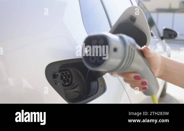 Female hands disconnect and show DC fast charging socket Europe type ...