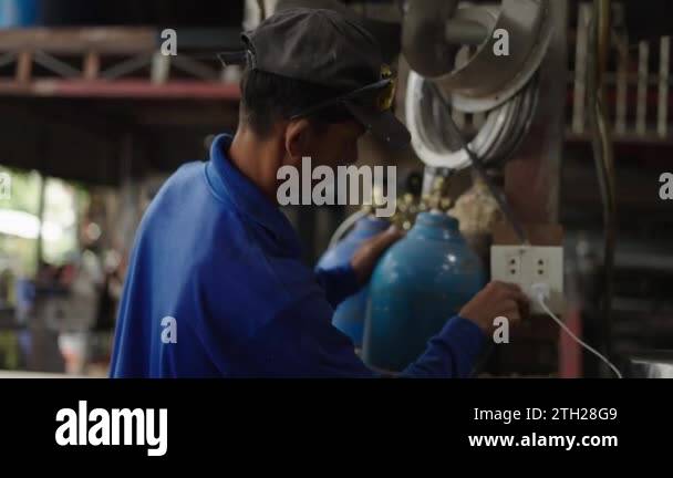Adult Thai Man Plugging A Tool Into A Socket In A Factory 4k Horizontal Video Stock Video