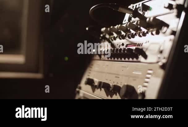 Man turning controls on amplifier during work in recording studio Stock ...