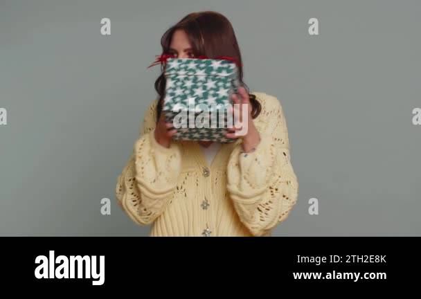 Happy pretty woman opening gift box, unwrapping birthday surprise and ...