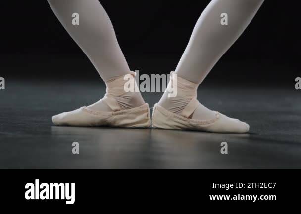 Unrecognizable girl dancer ballerina female legs rise lifting up pointe ...