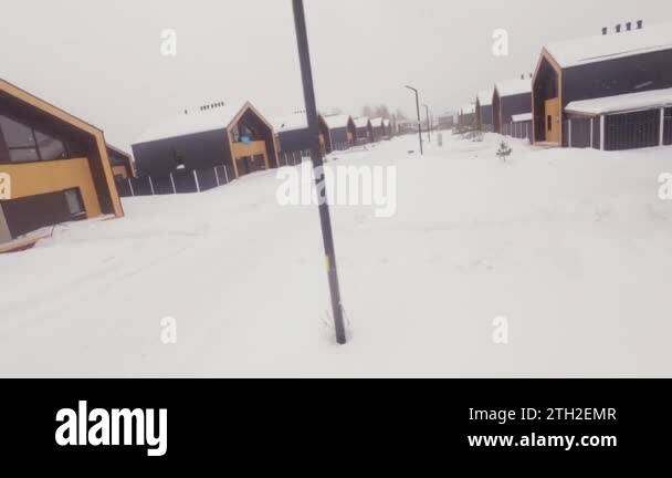 Mansions with snowy roofs in residential district on cold winter ...