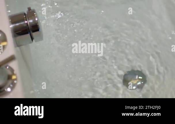 POV to the water flow out into the bathtub surface relaxation spa time ...