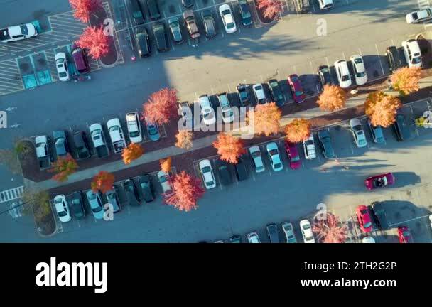 Aerial view of large parking lot with many parked colorful cars ...