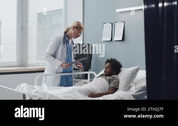 Locked down of Black boy with oxygen tube in nose lying in bed, then ...