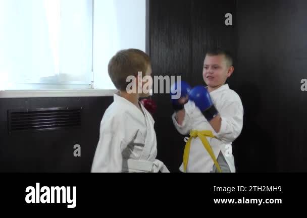 Two athletes with red and blue pads on their hands are training paired ...