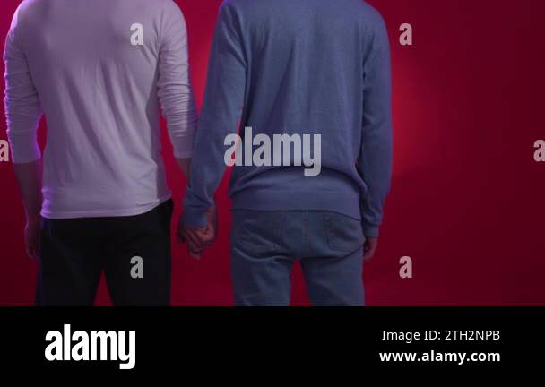 Gay relationship. Casual men. Love acceptance. Unrecognizable two guys holding hands and ...