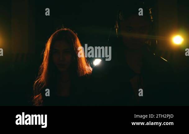 a couple of devil worshipers in black robes walk together in the middle ...