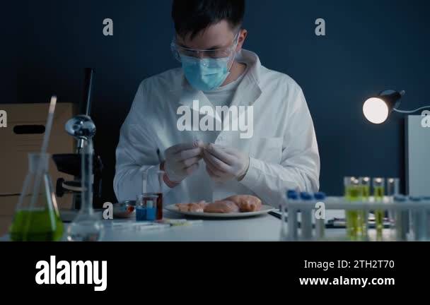 Scientist dripping red liquid on cultured meat, waiting for reaction in ...