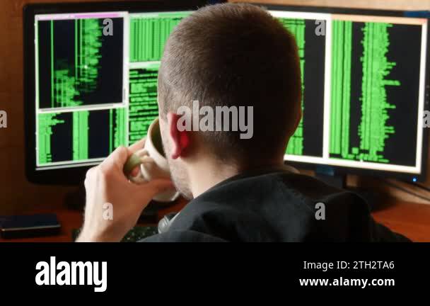 Hacker breaking code and drinking from the cup at your desk. Criminal ...