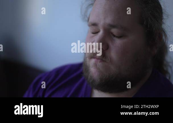One worried overweight young man close up face feeling anxiety and ...