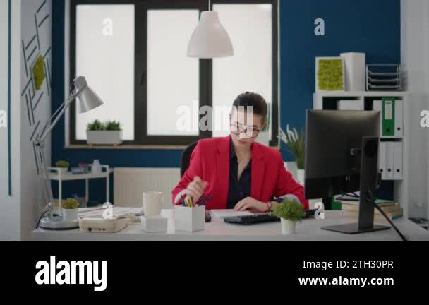 Sales assistant taking notes on documents to analyze charts, working ...