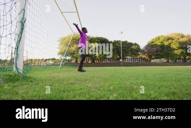 Video of african american goalkeeper on field, playing football. Male ...