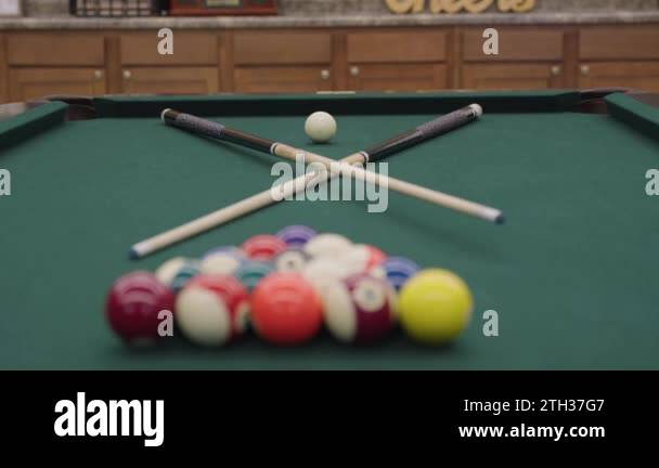 billiards pool table with crossed pool cues in a game room Stock Video ...