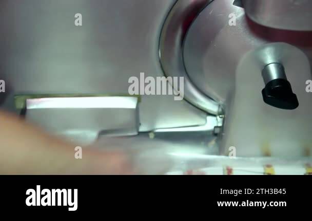 Female Employee Uses An Electric Meat Slicer To Cut Meat In The ...