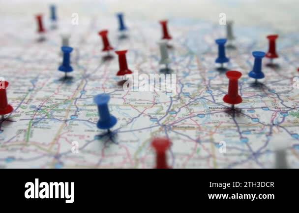 Camera flight revealing red white and blue pins placed marking cities ...