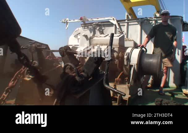 The ship cast anchor. Anchor chain with a loud sound goes into the ...