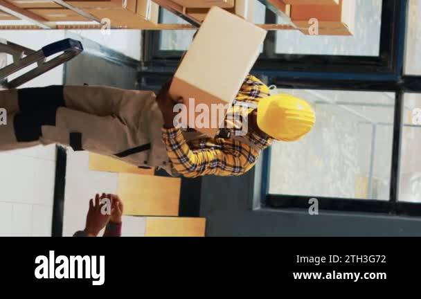 Vertical video: Group of people working on stock logistics in depot ...