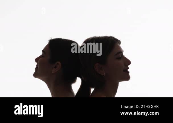 Female relationship. Tranquil happiness. Silhouette portrait. Smiling ...